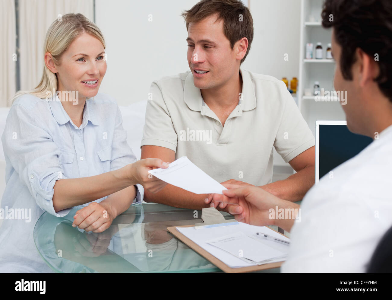 Couple receiving prescription from their doctor Stock Photo - Alamy