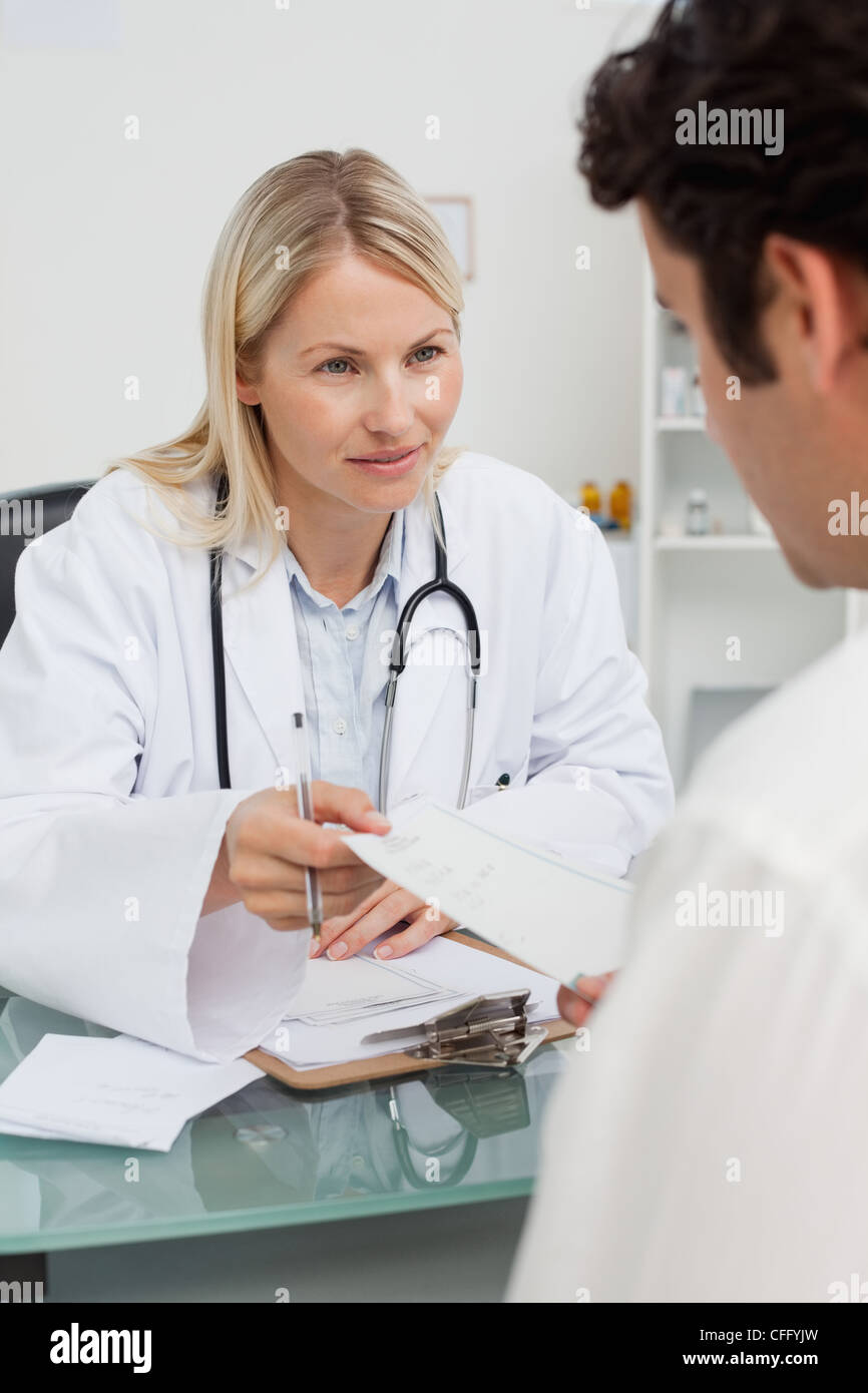 Doctor giving prescription to patient Stock Photo - Alamy