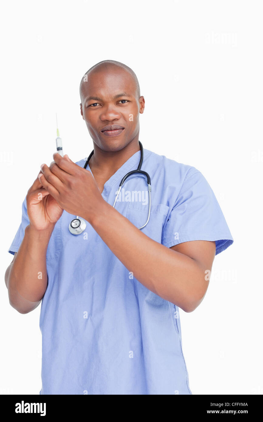 Doctor in scrubs preparing syringe Stock Photo - Alamy