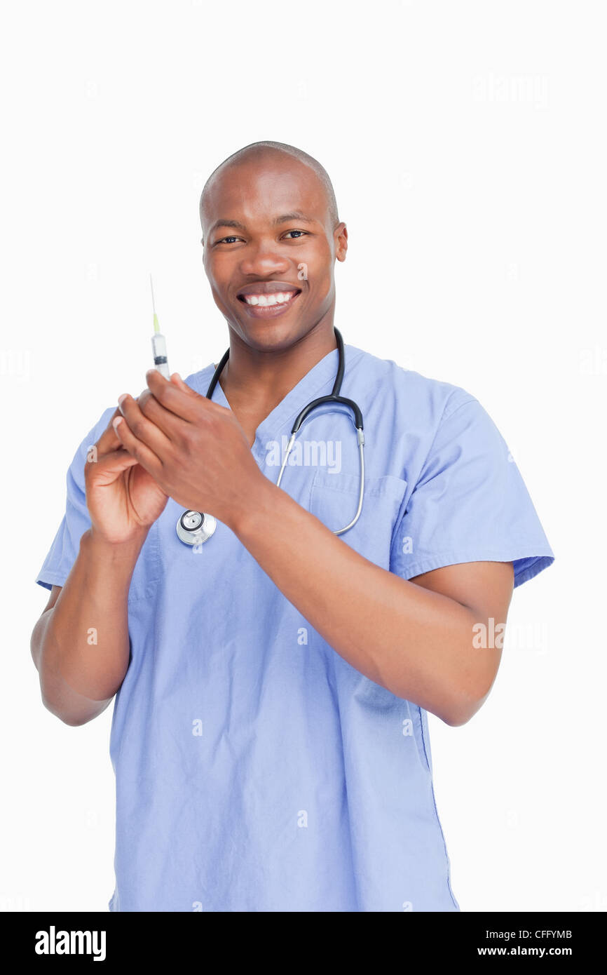 Smiling doctor in scrubs preparing syringe Stock Photo - Alamy