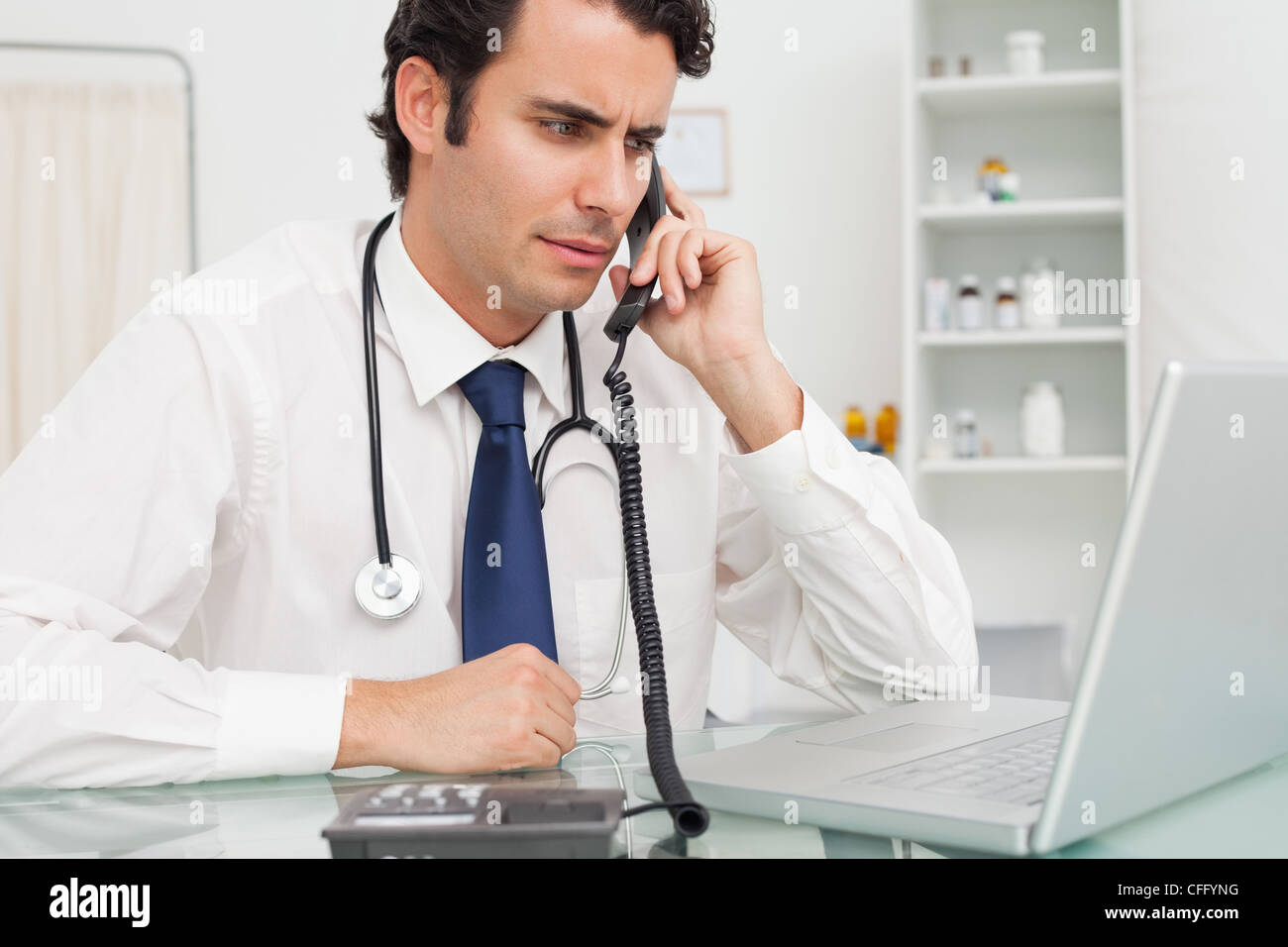 Doctor on his phone Stock Photo - Alamy