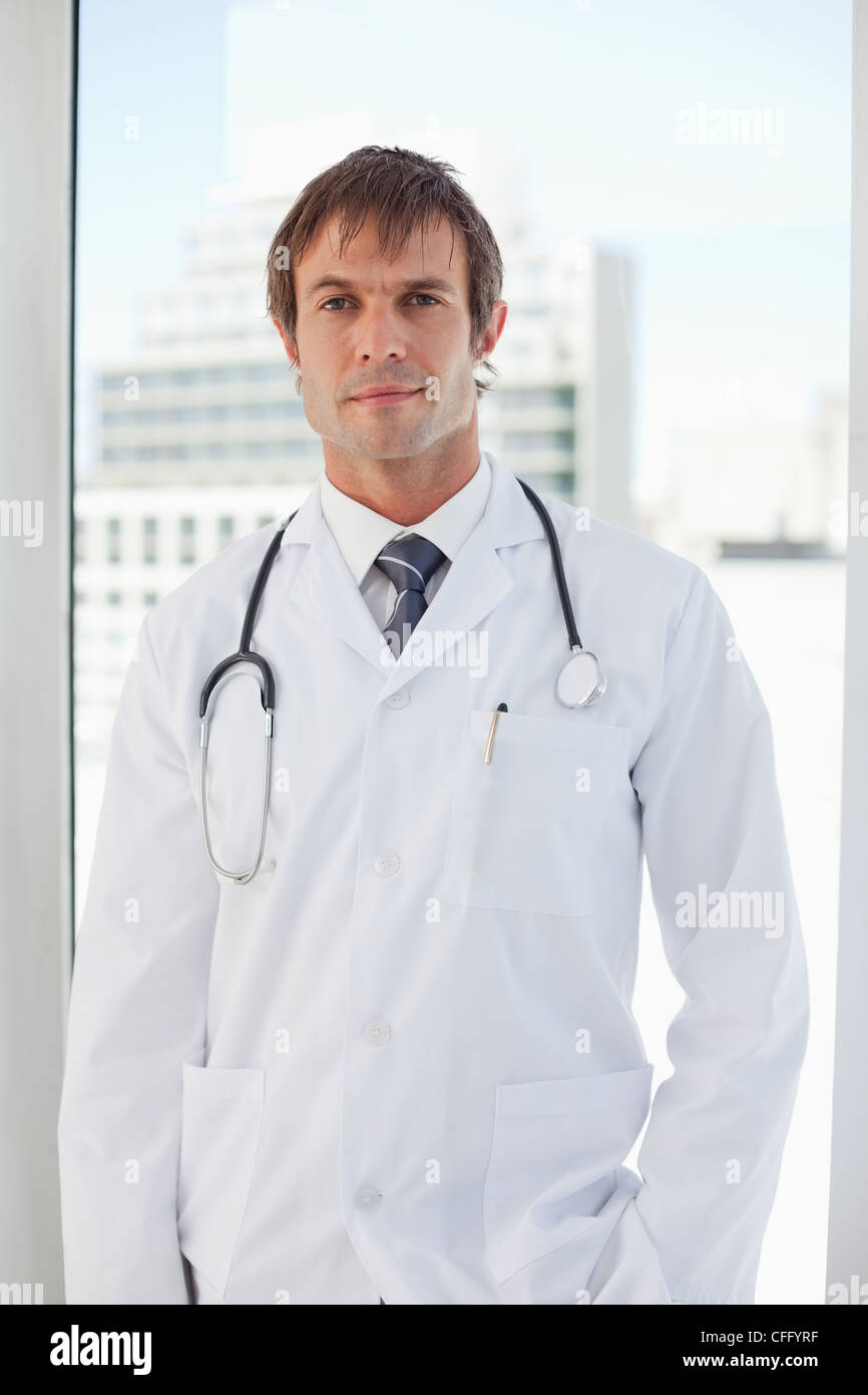 Surgeon standing upright in front of a window Stock Photo - Alamy