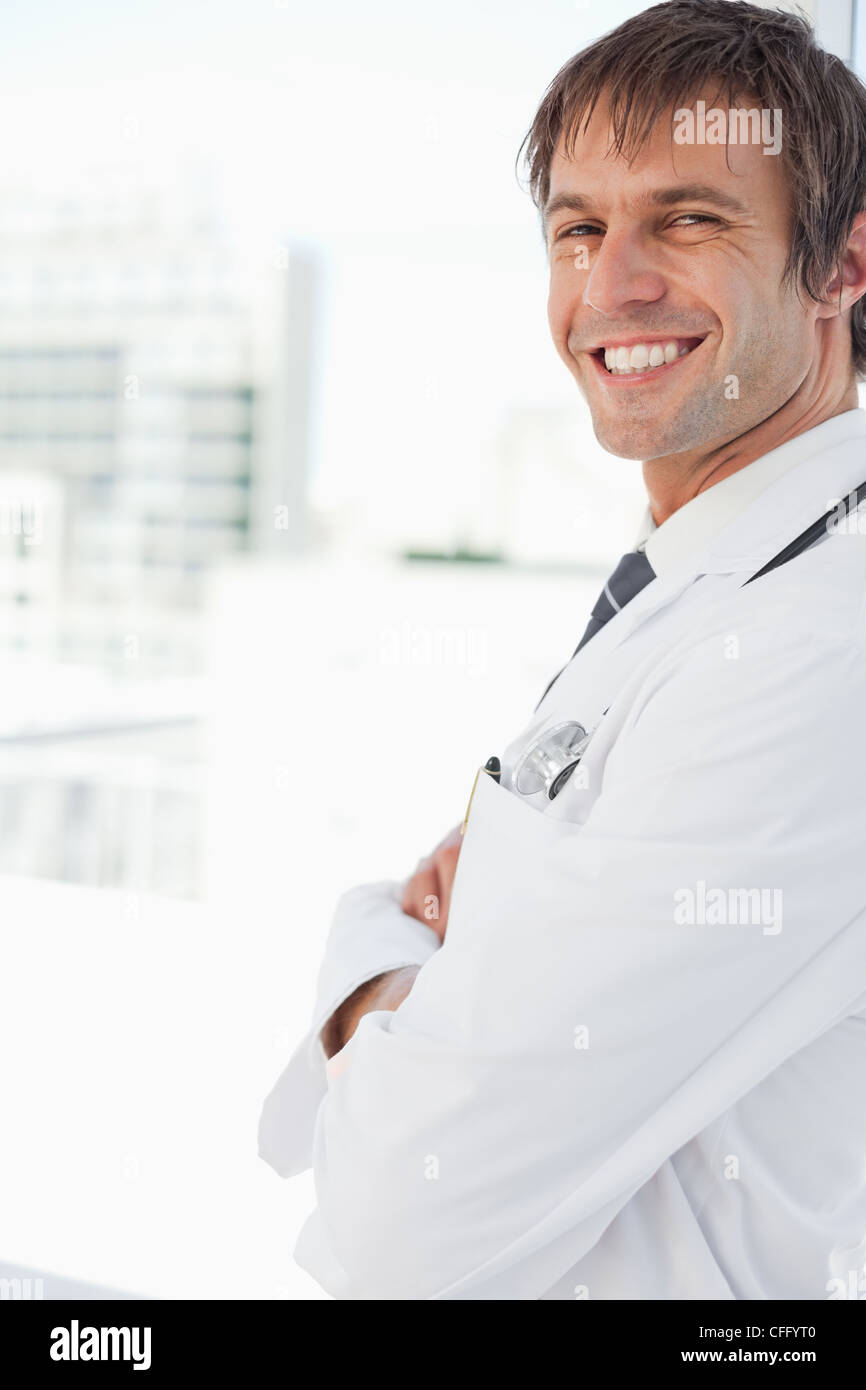 Side view of a doctor smiling while looking at the camera Stock Photo ...