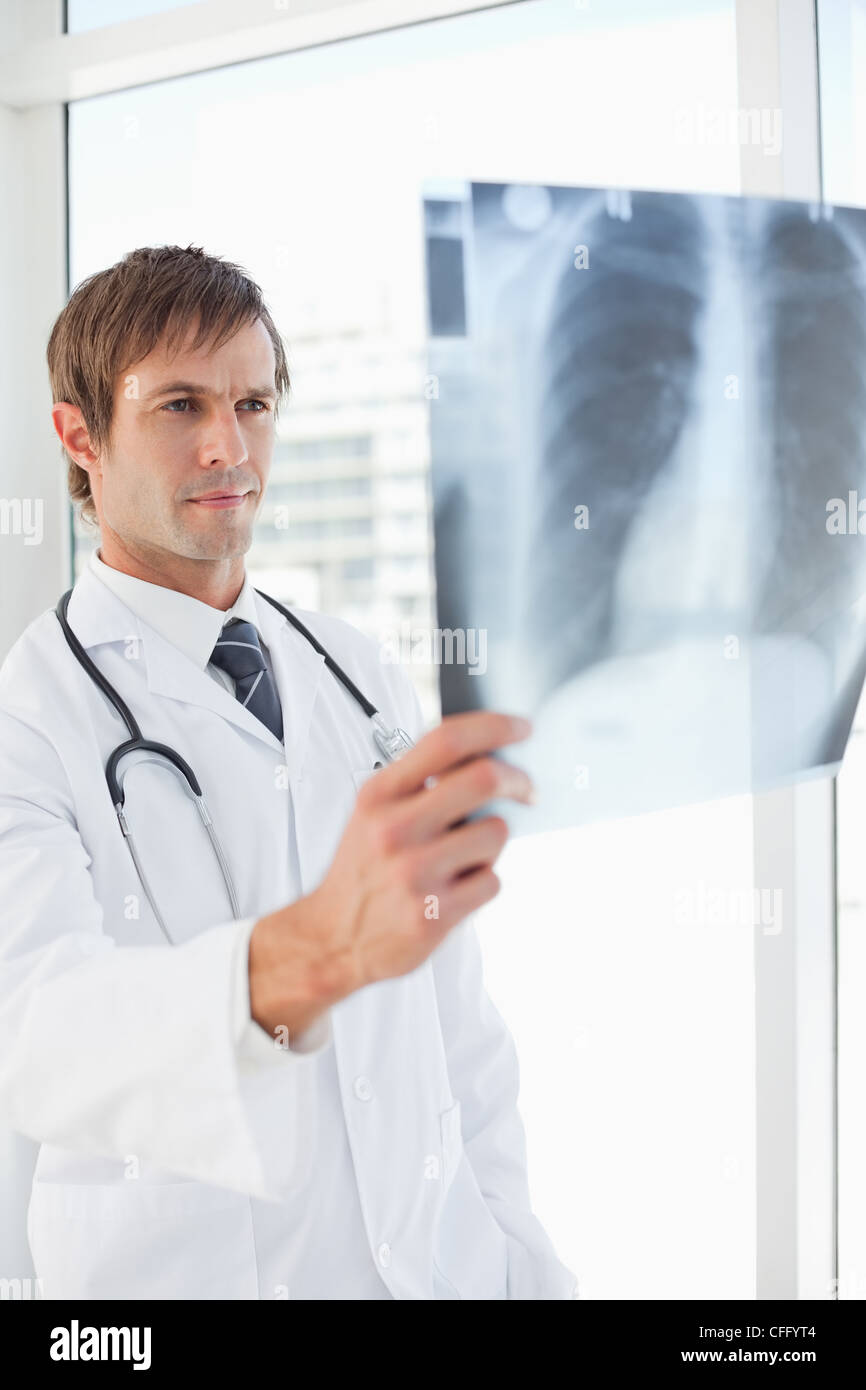 Serious surgeon holding a chest x-ray Stock Photo - Alamy