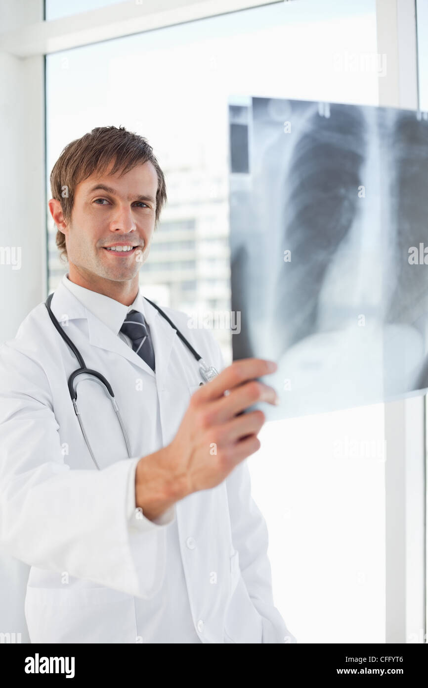 Young smiling doctor holding a chest x-ray Stock Photo - Alamy