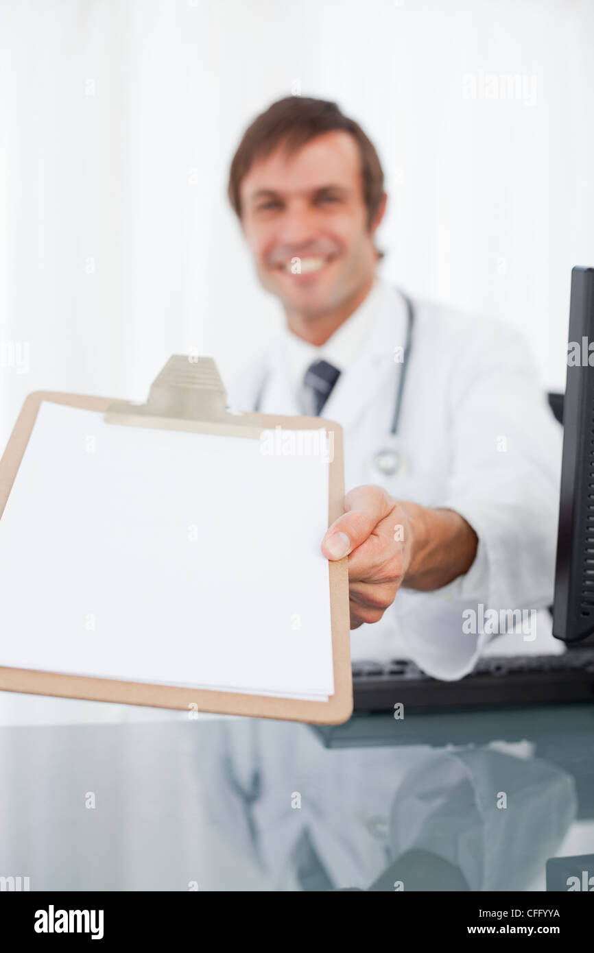 Clipboard held by a smiling doctor Stock Photo - Alamy