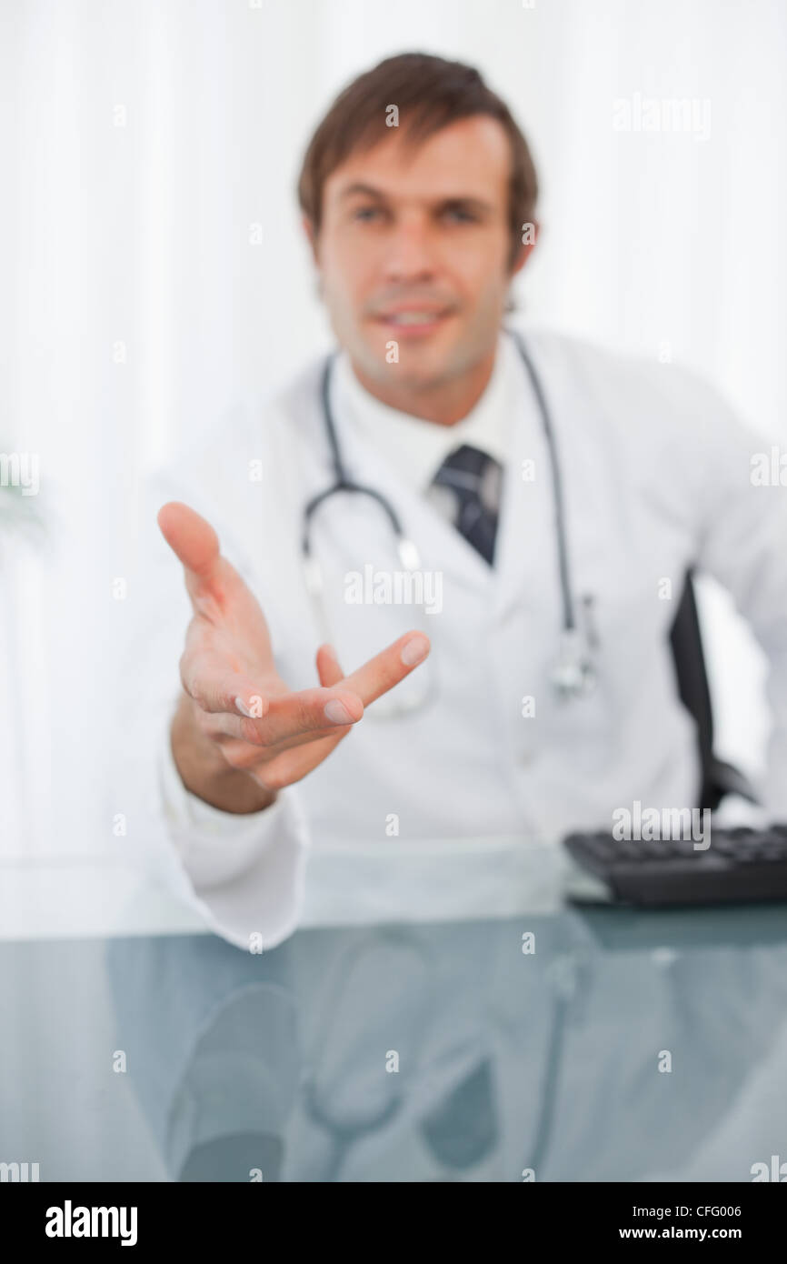 Hand extended by a smiling doctor Stock Photo - Alamy