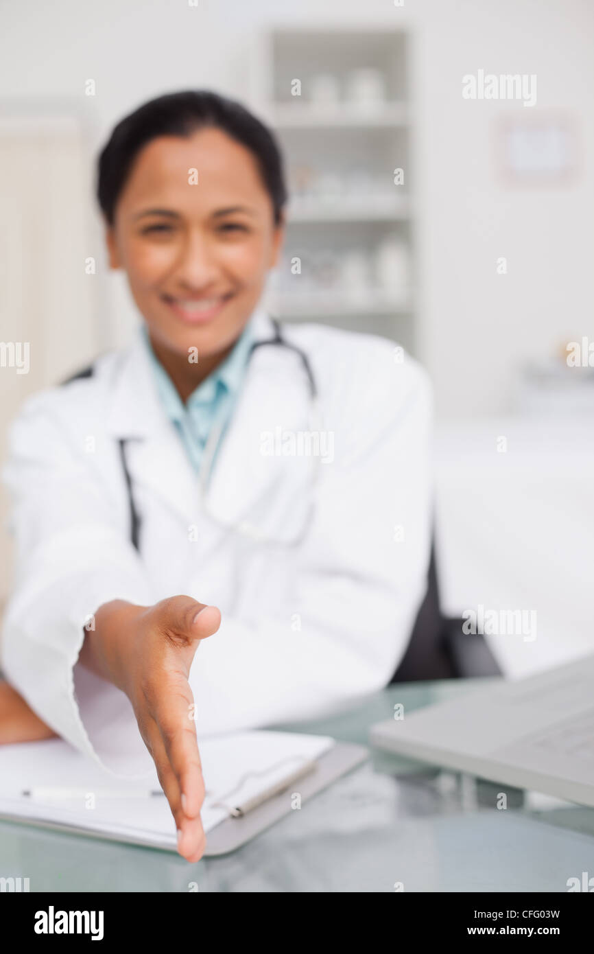 Hand extended by a smiling doctor Stock Photo - Alamy