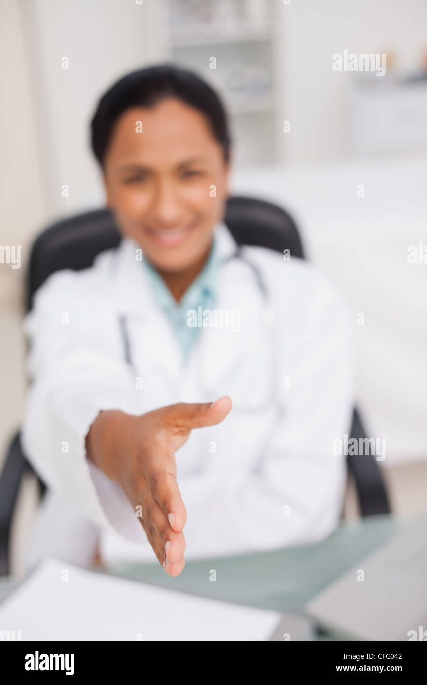 Hand being offered out by a smiling doctor Stock Photo - Alamy