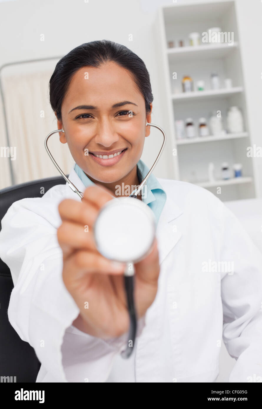 Smiling doctor wearing her stethoscope Stock Photo - Alamy