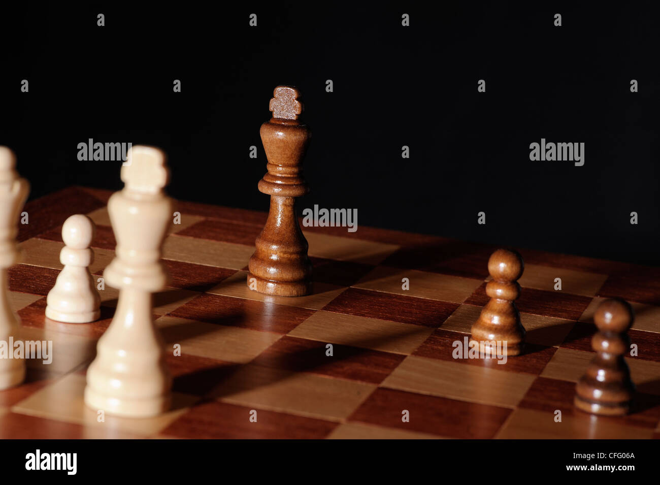 Chess endgame - king under pressure. Dramatic scene with long shadows ...