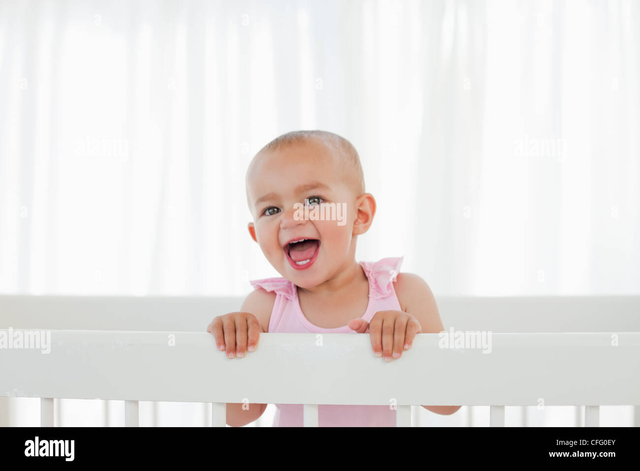 Baby standing up in cot hi-res stock photography and images - Alamy