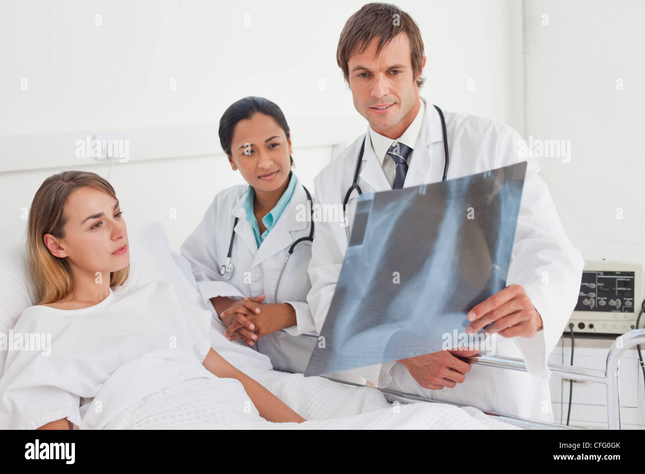 Two doctors and a patient looking at a chest x-ray Stock Photo - Alamy