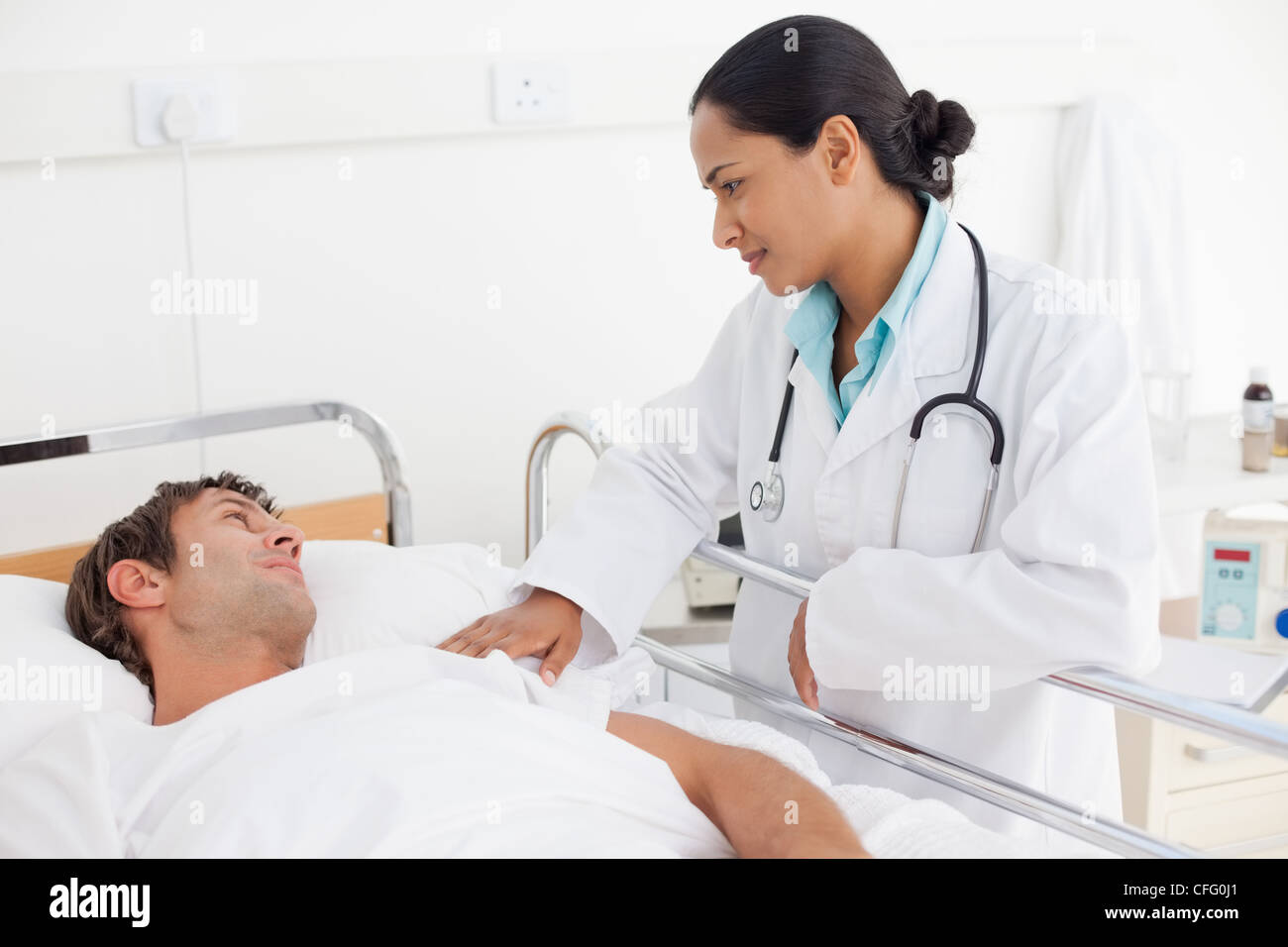 Relaxed doctor touching her patient while looking compassionate Stock ...