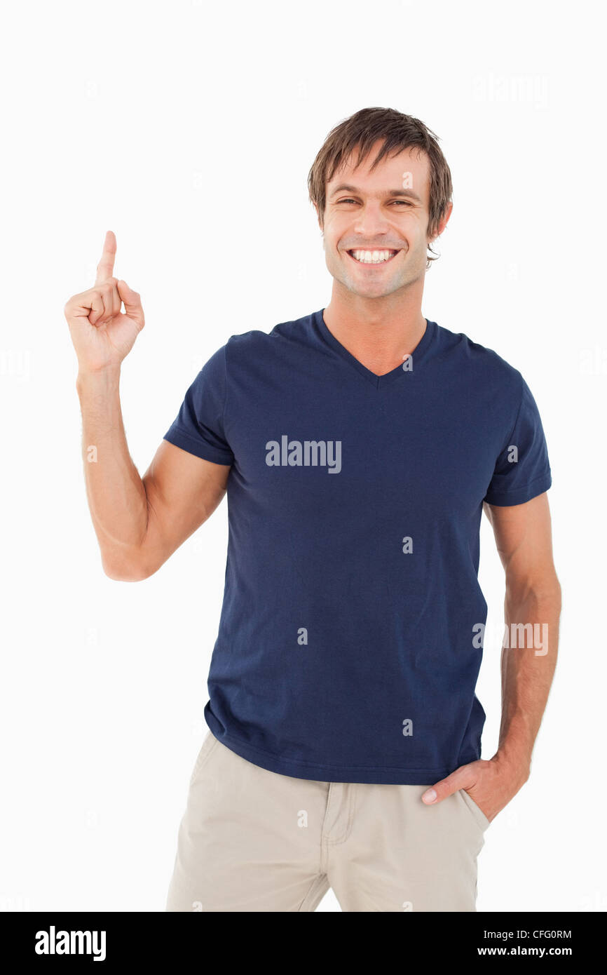 Smiling man looking at the camera while pointing his finger up Stock ...