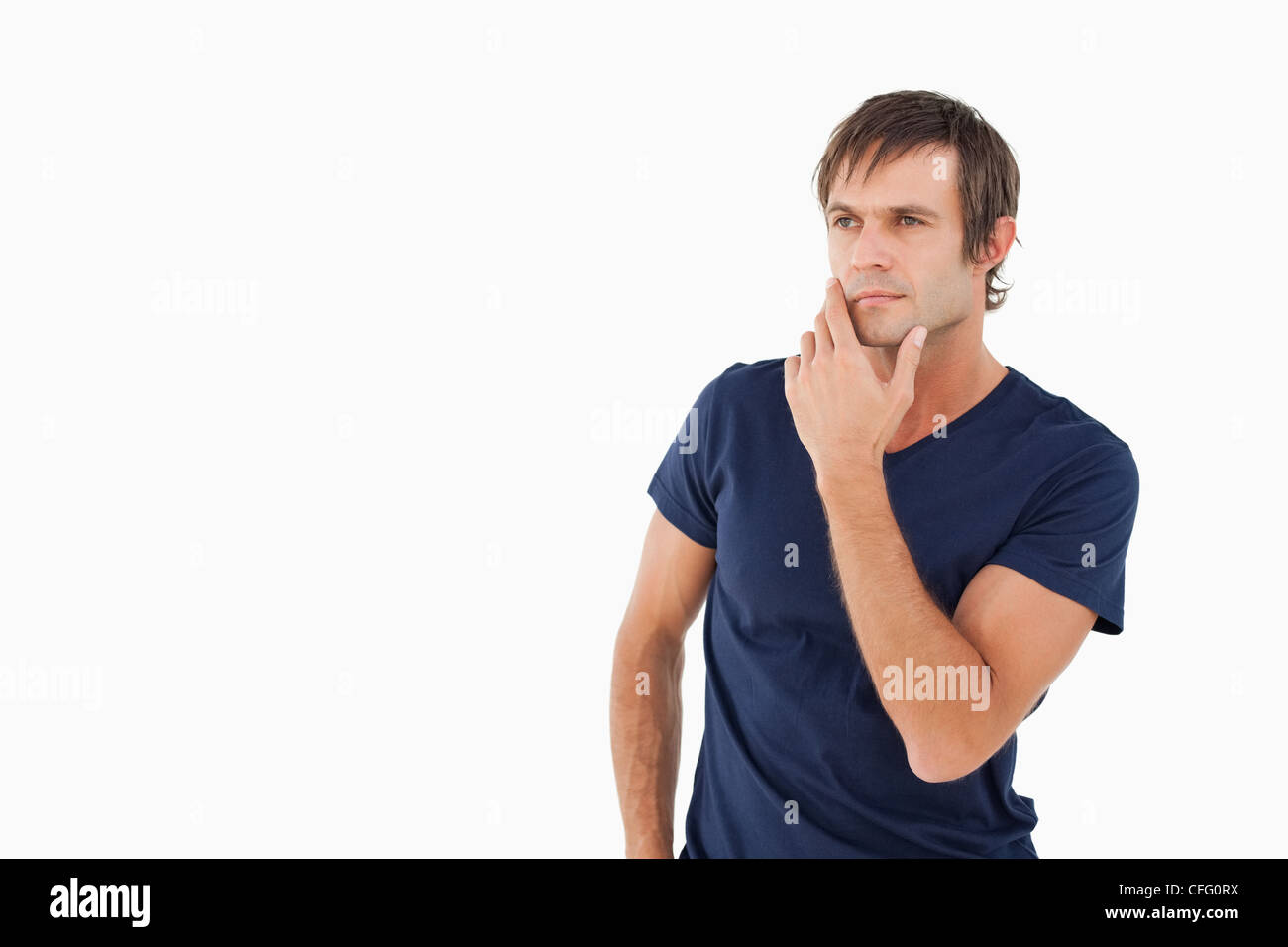 Thoughtful man looking away while placing his hand on his chin Stock ...