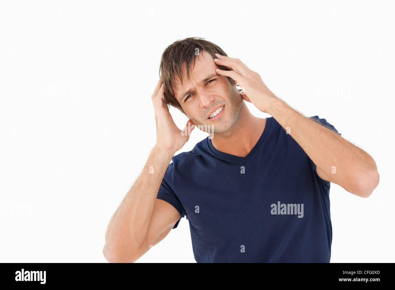 Man tilting his head while showing a headache Stock Photo - Alamy