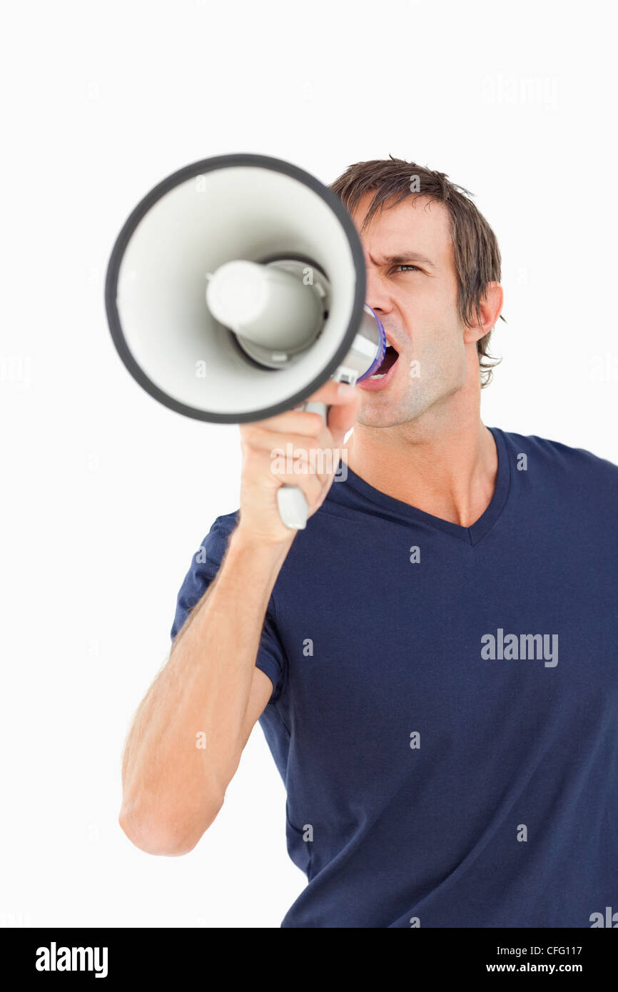 Furious man standing up while shouting and using a megaphone Stock ...