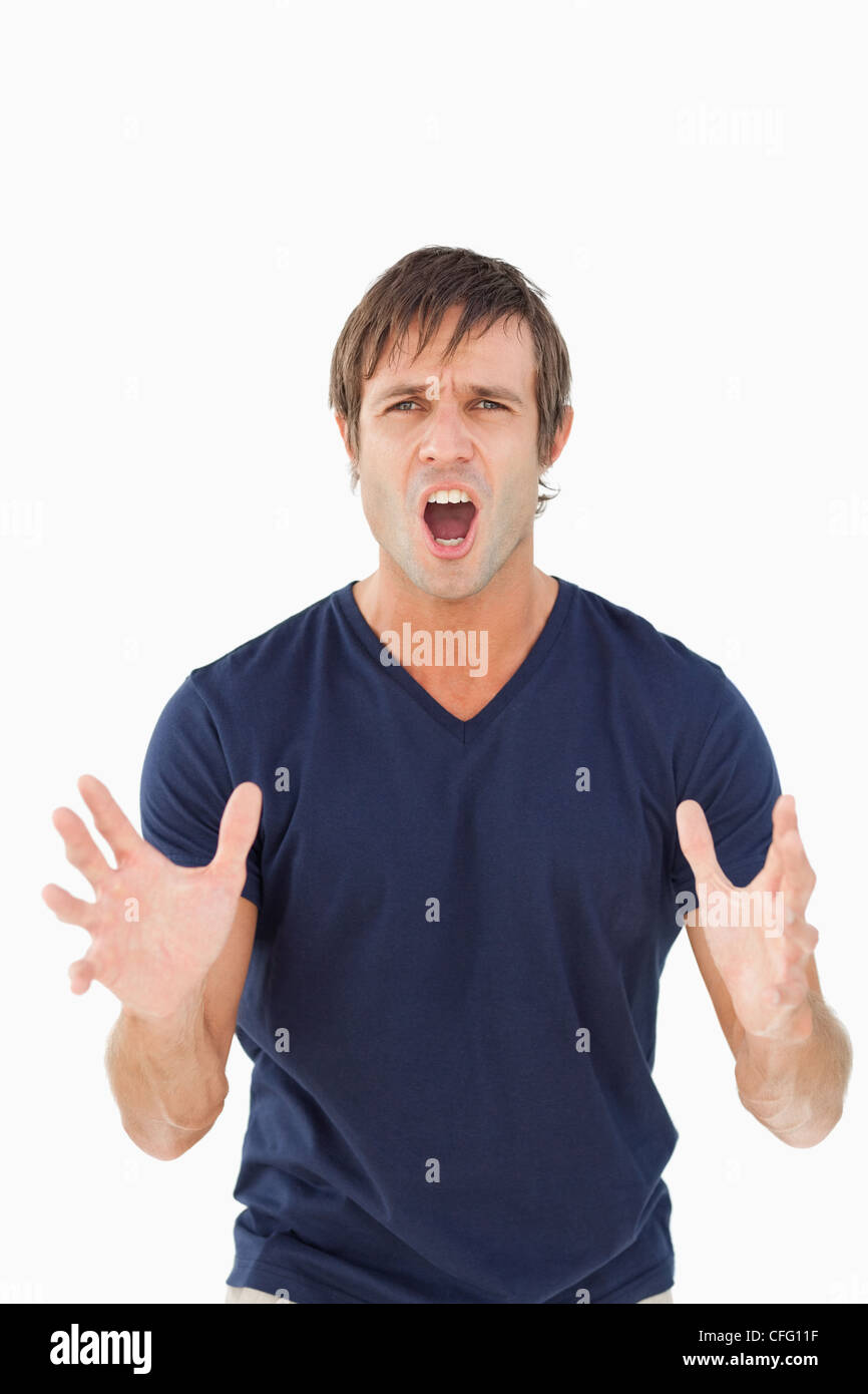 Man shouting while raising his hands Stock Photo - Alamy