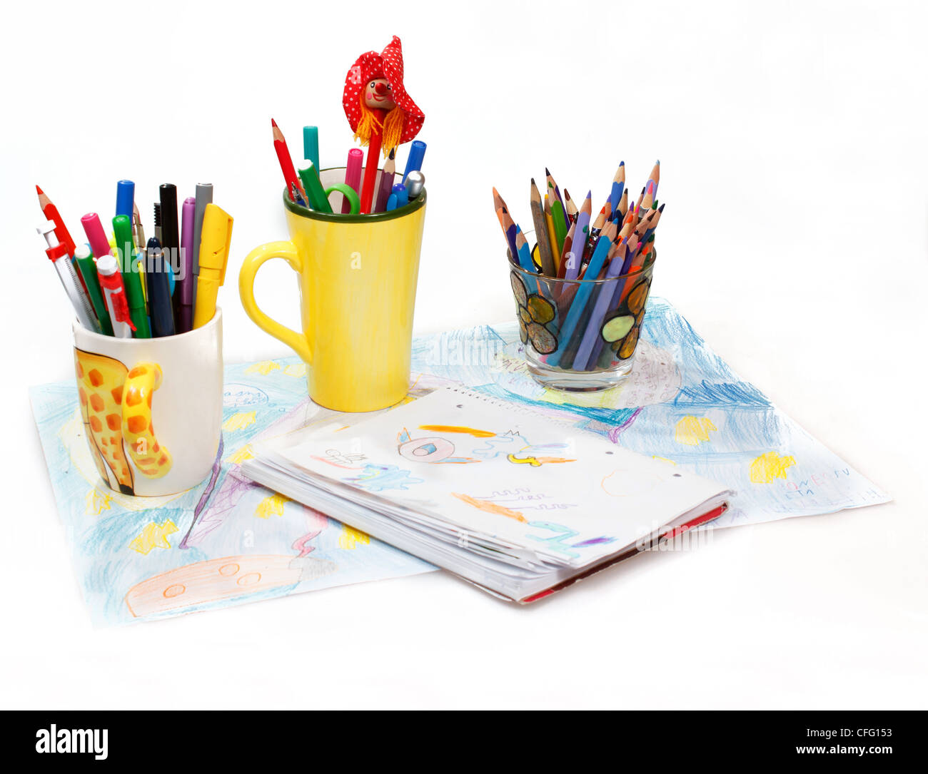Abstract painting and pen holders with colored pens on a white ...