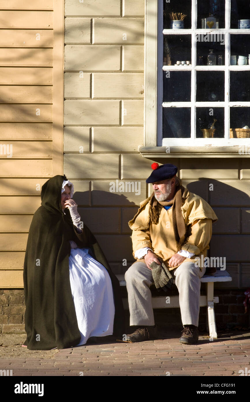 A female and male interpreter sitting on a bench at a shop in Virginia ...