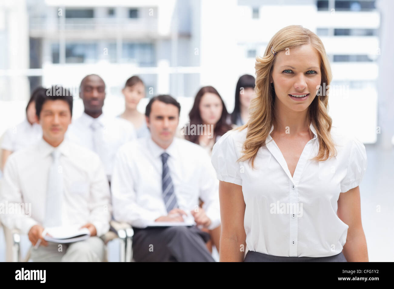 Brunette haired woman looking ahead while standing in front of her ...