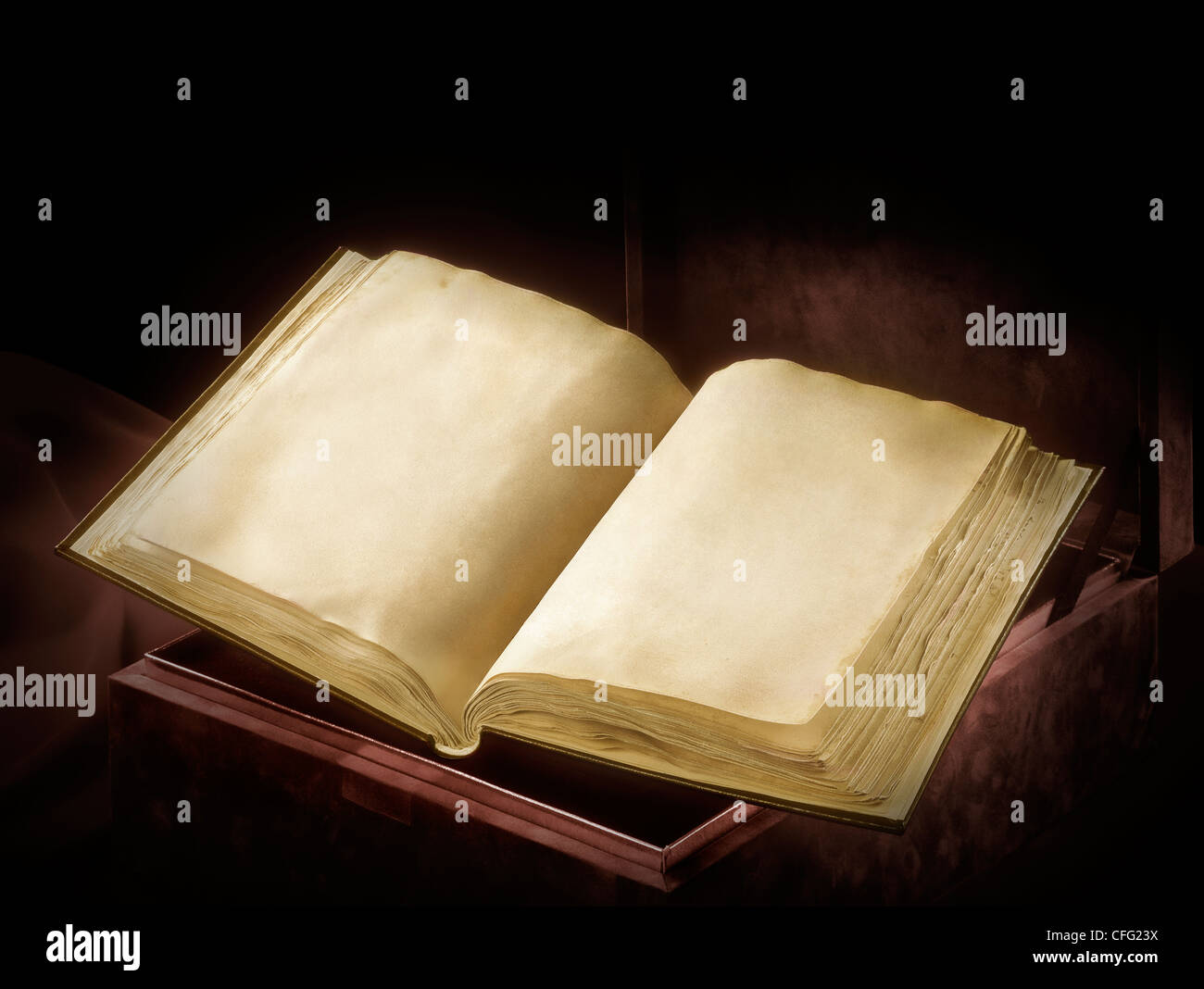 Ancient book laying on a box with blank pages. Black background Stock ...