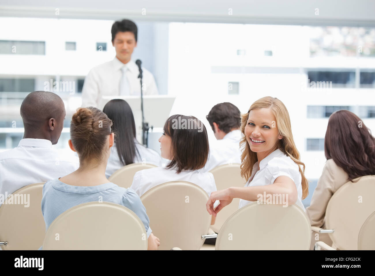 Woman looking behind he during a speech Stock Photo - Alamy