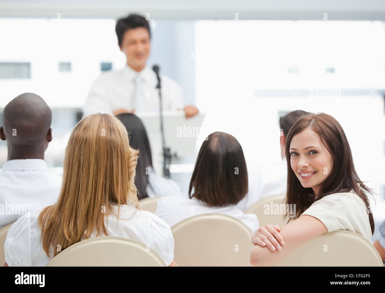 Happy businesswoman looking behind her during a presentation Stock ...