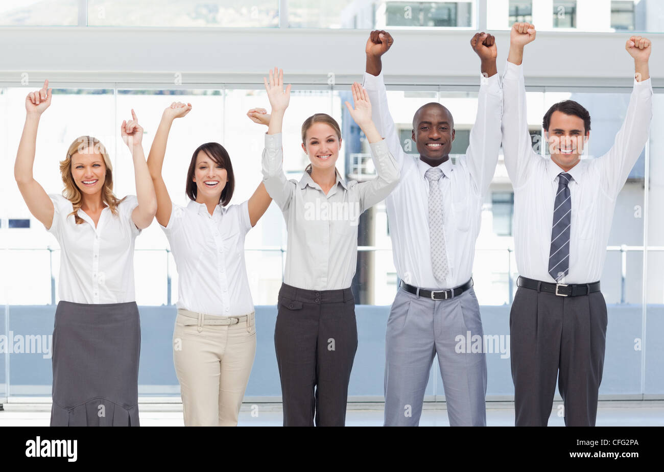 Business team raising their arms above their head Stock Photo - Alamy