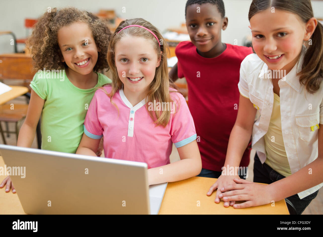Smiling students using laptop Stock Photo - Alamy