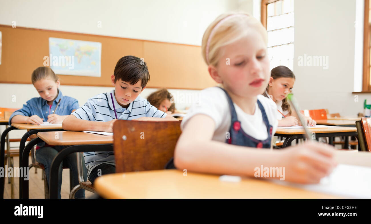 Three primary school students working hi-res stock photography and ...