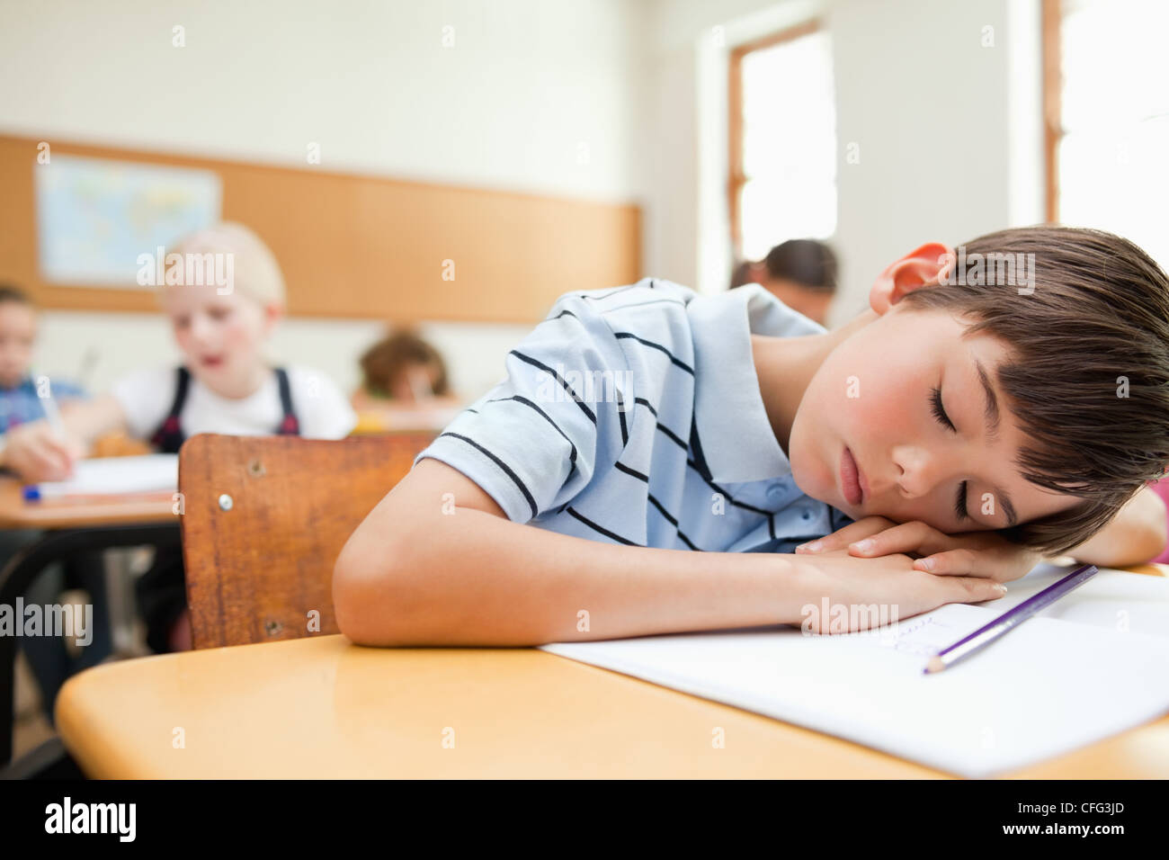 Tired student taking a rest at his desk Stock Photo - Alamy