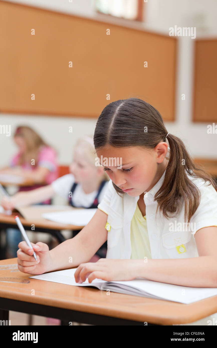 Primary student working on exercise book Stock Photo - Alamy