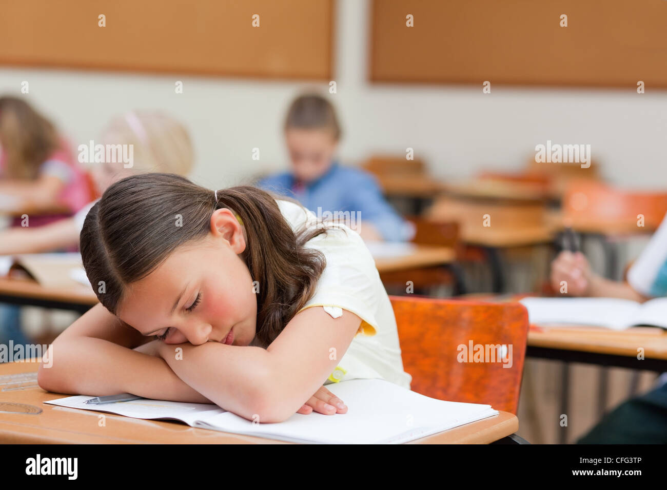 Primary student felt asleep at desk during class Stock Photo - Alamy