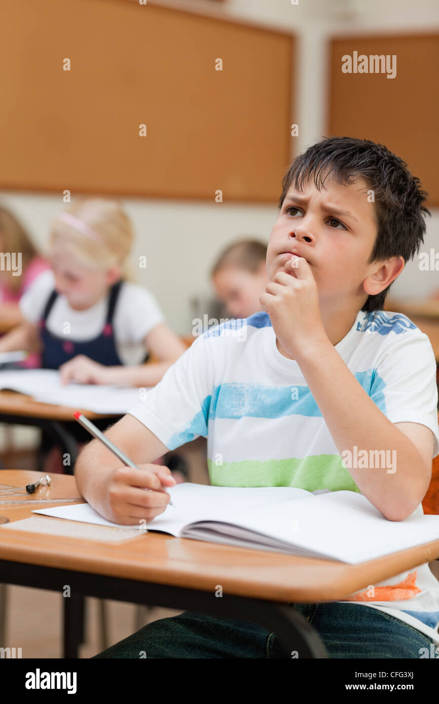 Schoolboy in thoughts during class Stock Photo - Alamy