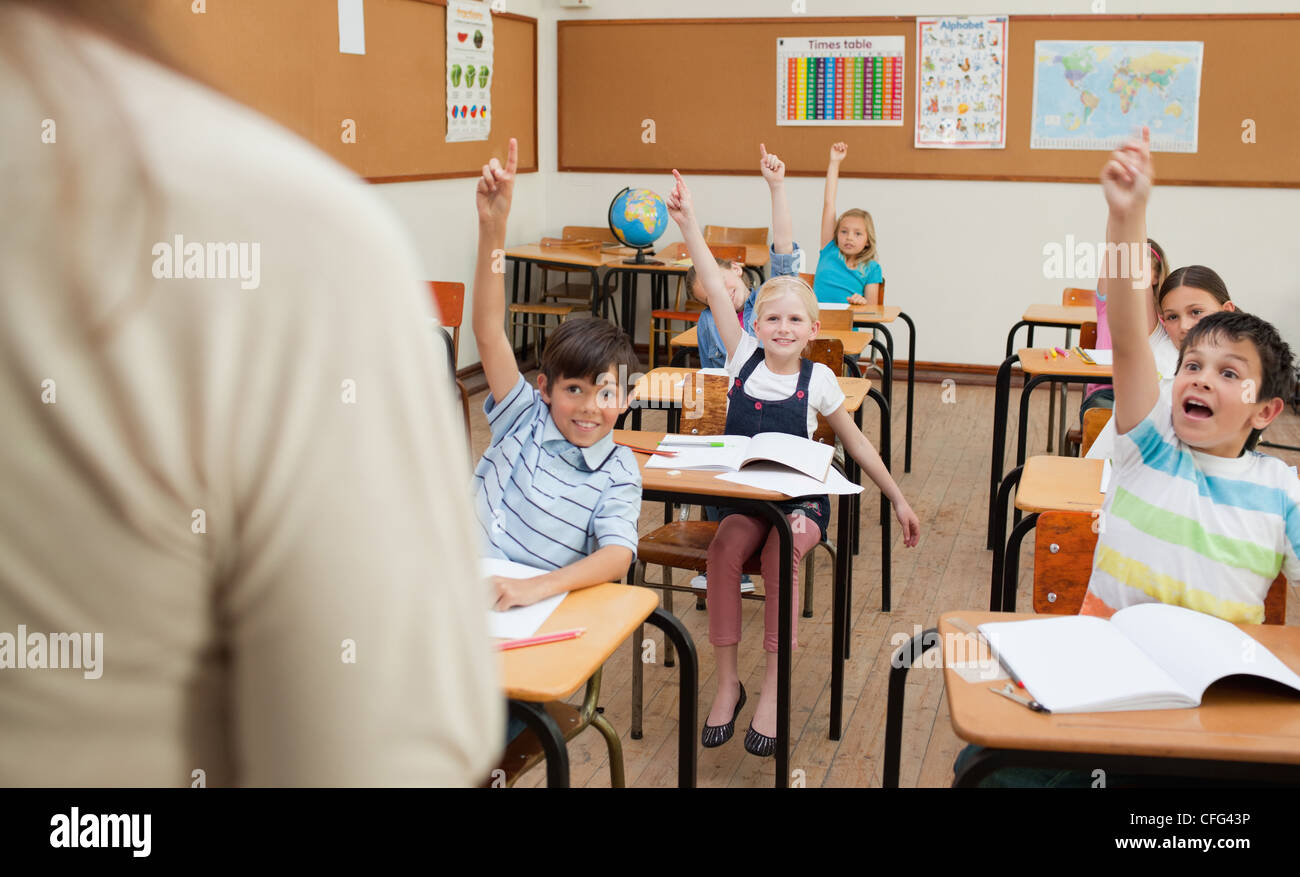 Students with finger raised in class Stock Photo - Alamy