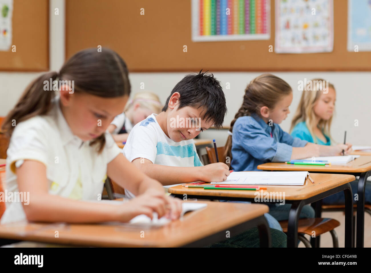 Side view of students doing their exercises Stock Photo - Alamy