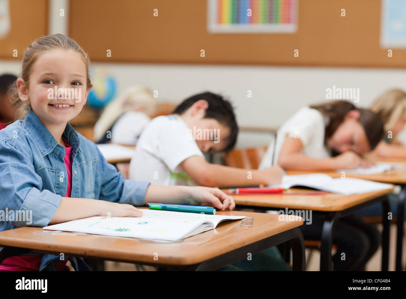 Side view of schoolgirl during class Stock Photo - Alamy