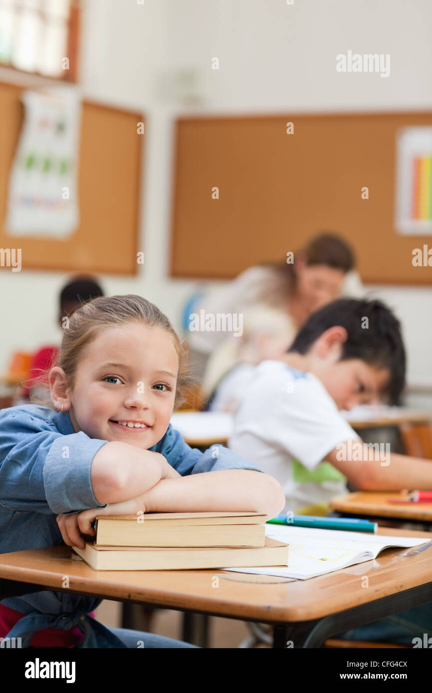 Side view of smiling student at her desk Stock Photo - Alamy