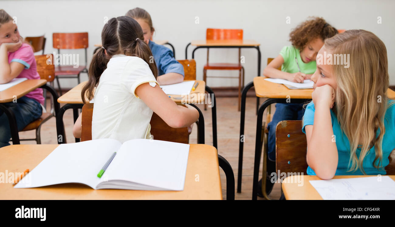 Schoolgirl turning around during class Stock Photo - Alamy