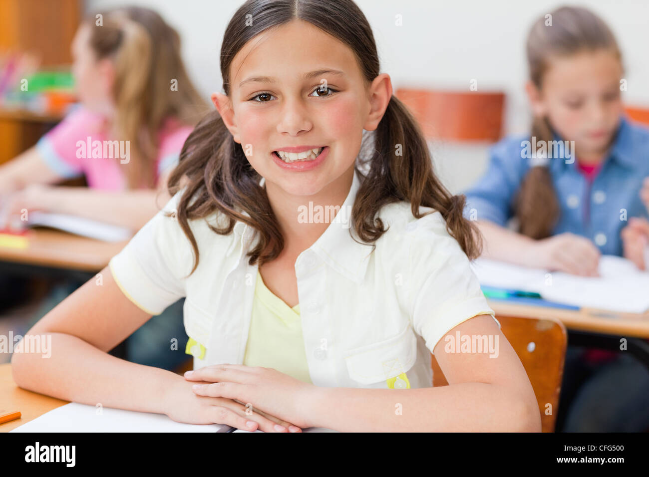 Smiling girl sitting in class Stock Photo - Alamy