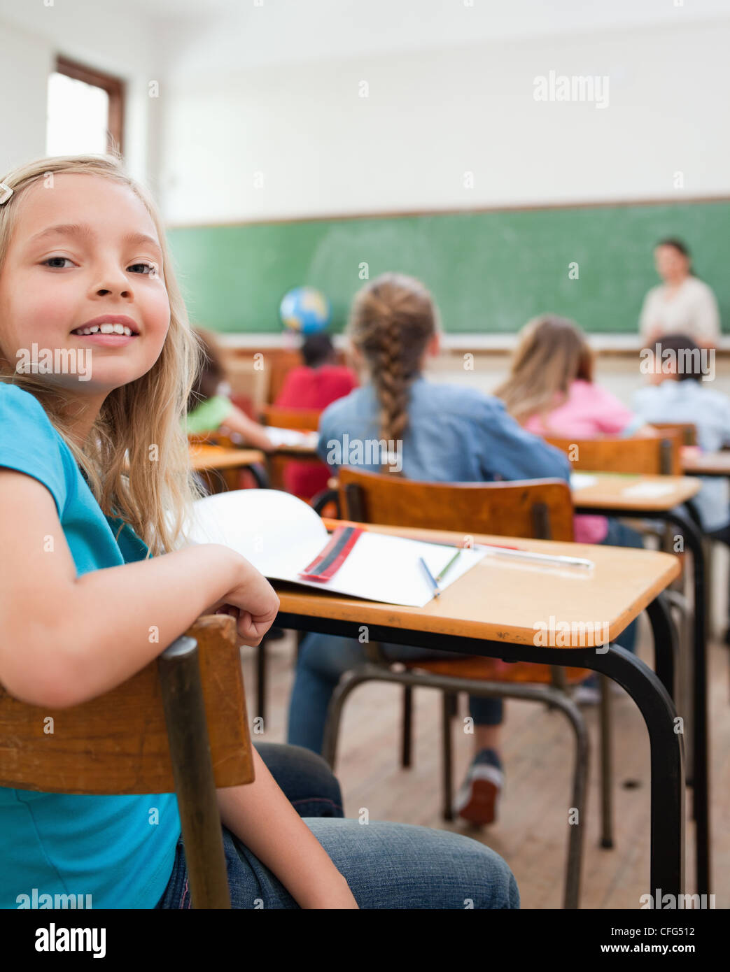 Girl sitting school desk turning hi-res stock photography and images ...