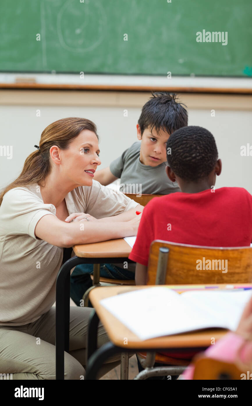 Teacher talking to one of her students Stock Photo - Alamy