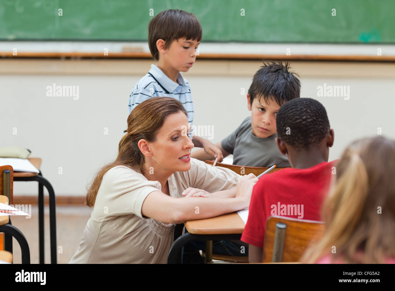 Teacher talking with one of her students Stock Photo - Alamy