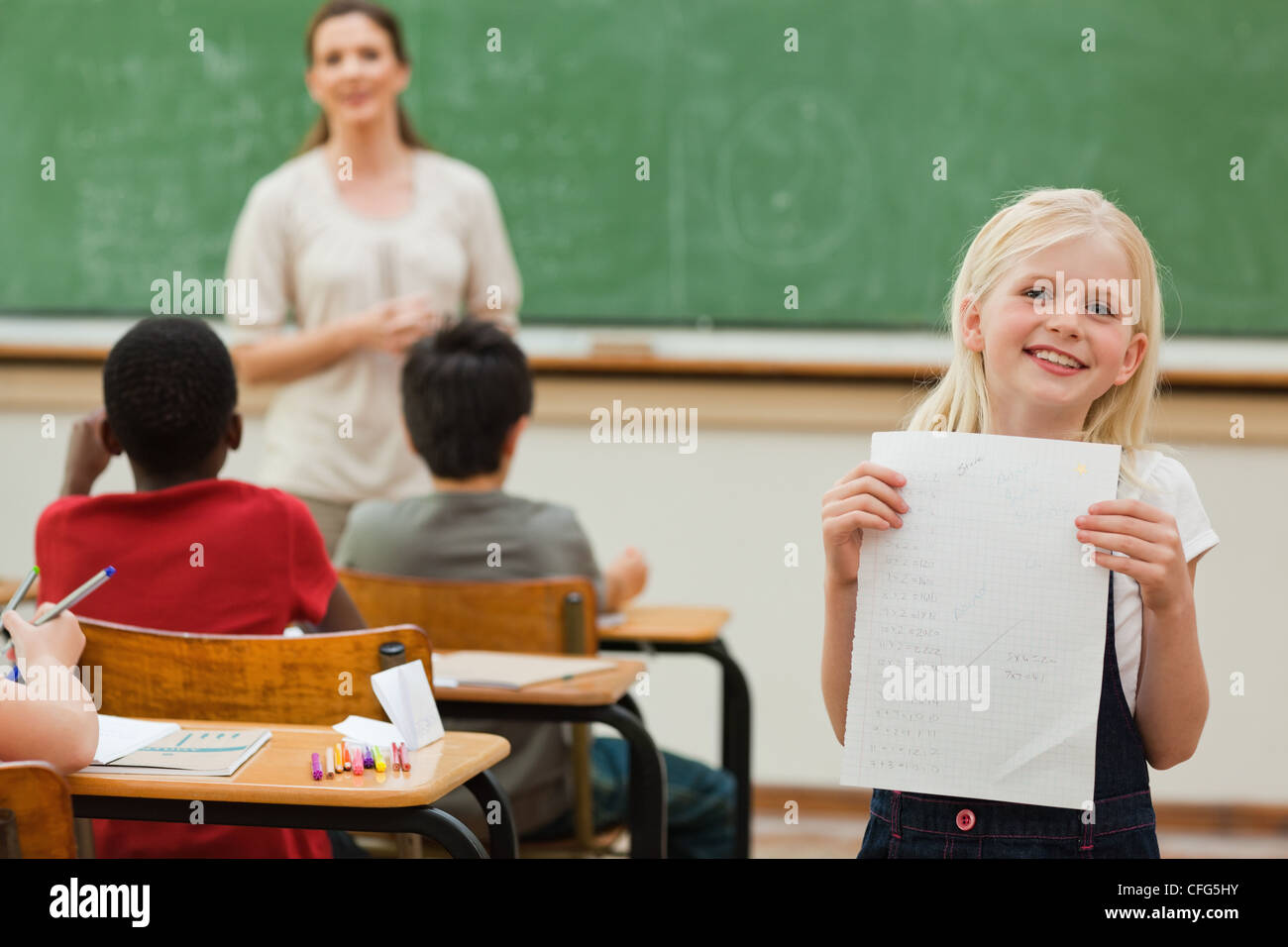 Smiling girl presenting her test results Stock Photo - Alamy