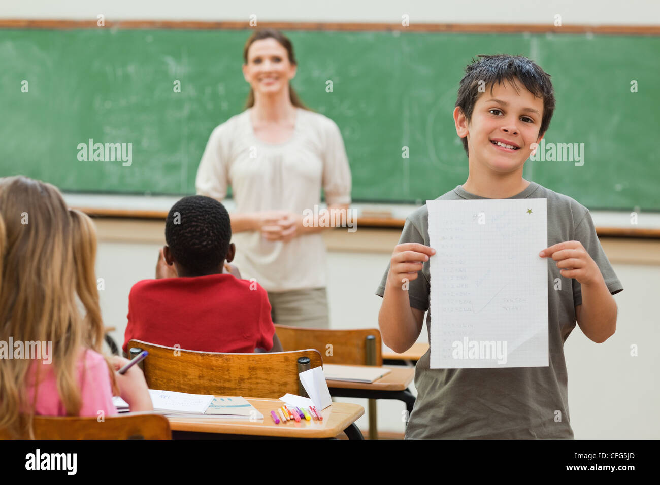 Smiling boy showing his test results Stock Photo - Alamy