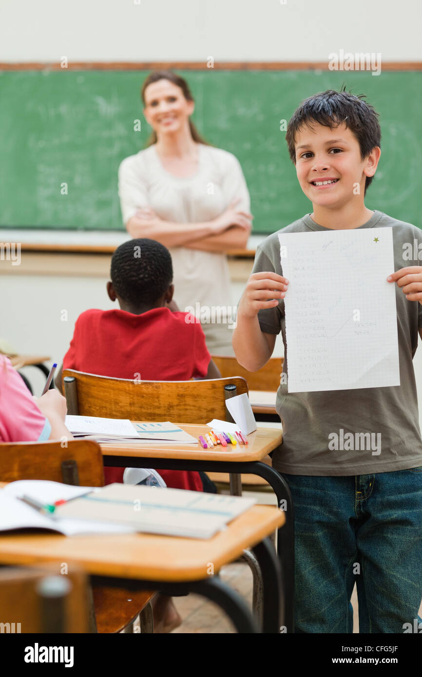 Smiling boy showing test results Stock Photo - Alamy