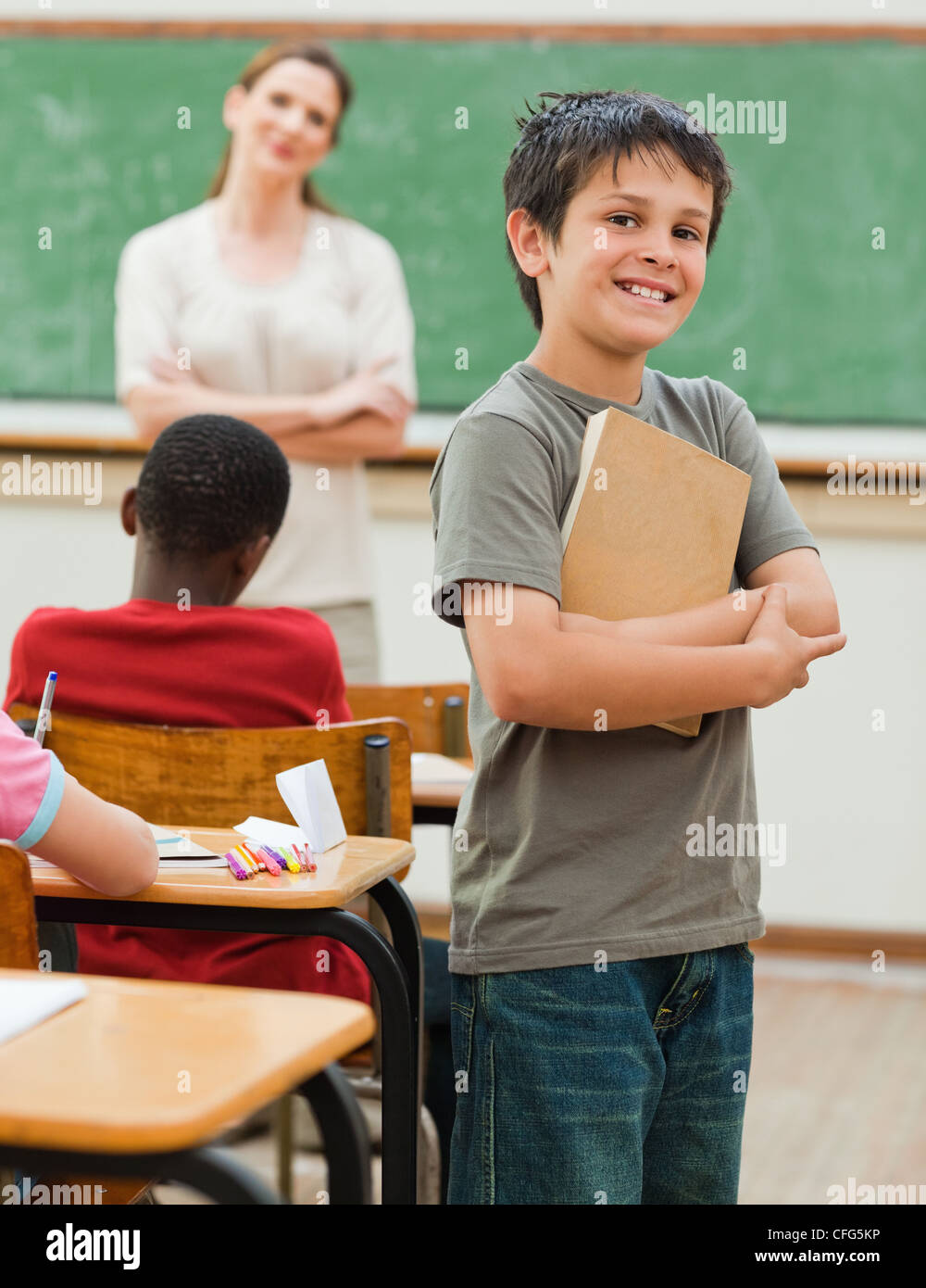 Smiling boy holding book Stock Photo - Alamy