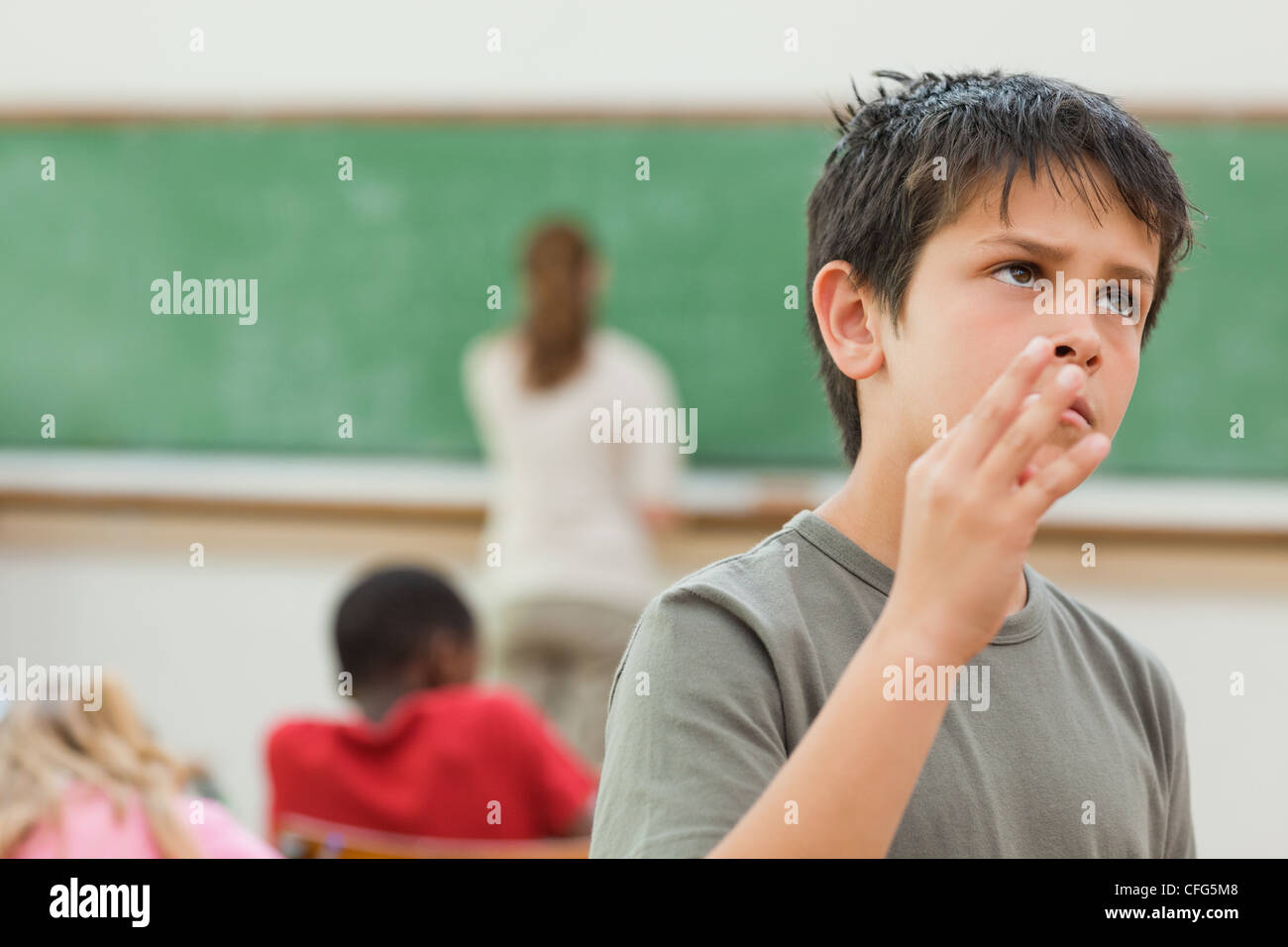 Boy acting cool in class Stock Photo - Alamy